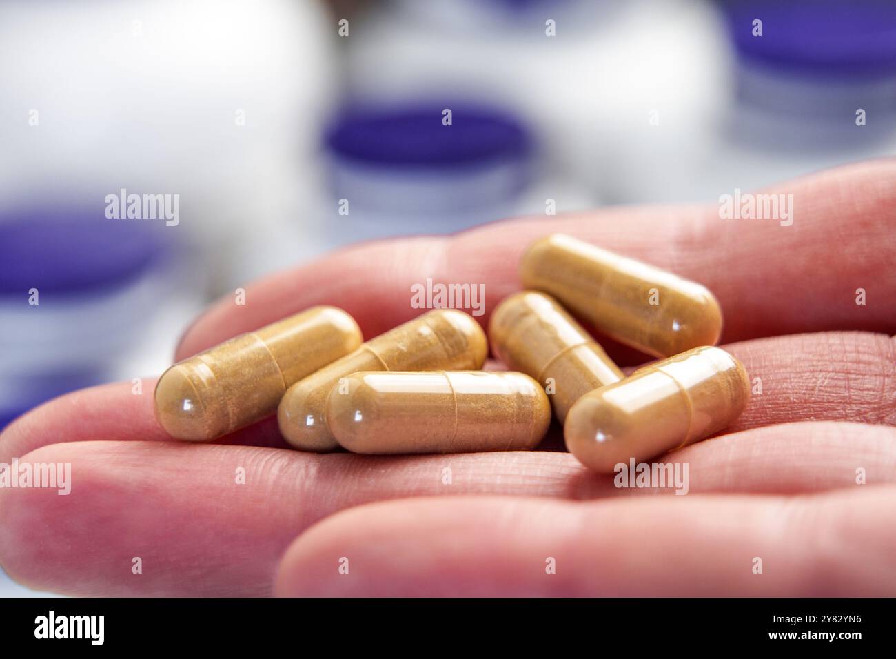 Hand holds natural capsules filled hi-res stock photography and images ...