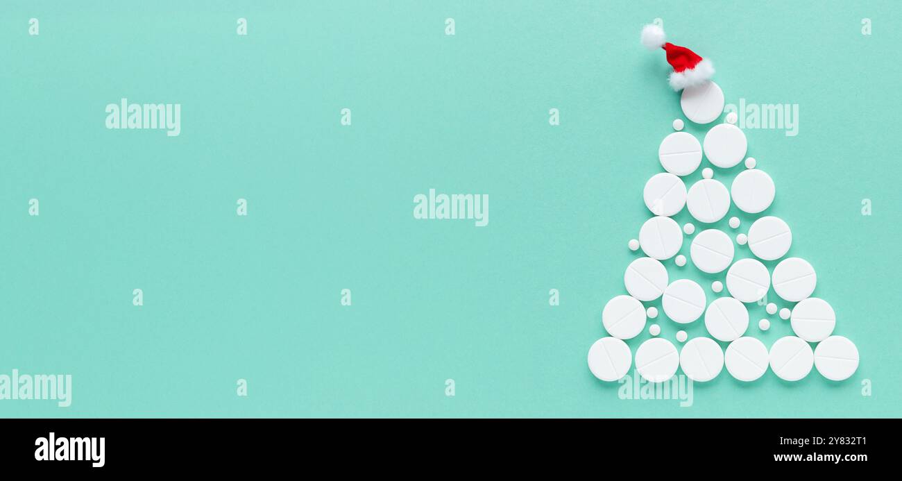 Creative arrangement of white pills forming Christmas tree with red ...