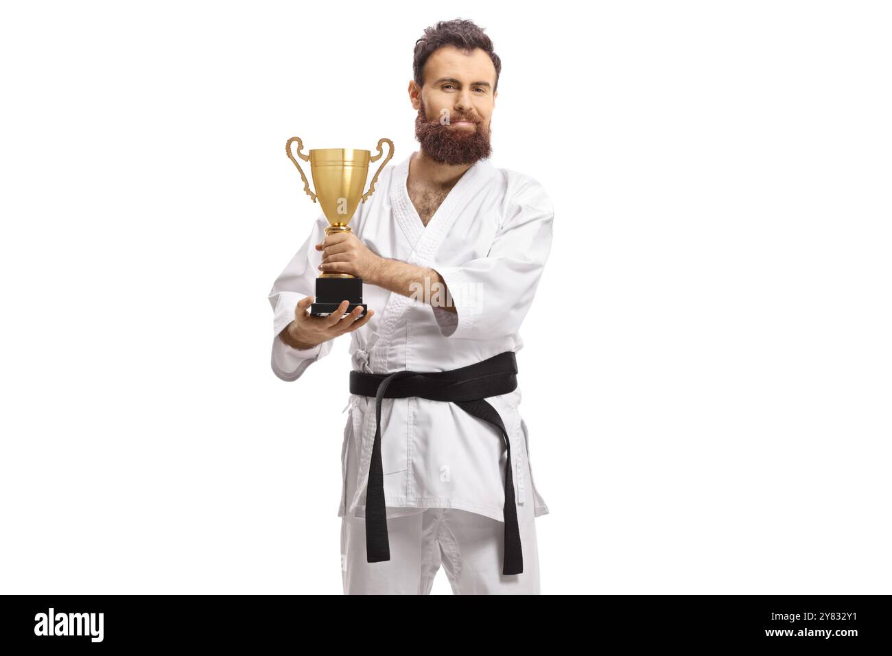 Karate champion in kimono with a trophy cup isolated on white ...
