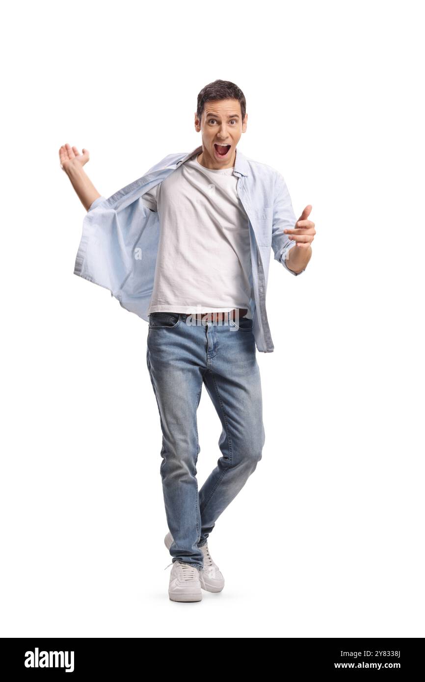 Young man in jeans dancing and shouting isolated on white background ...