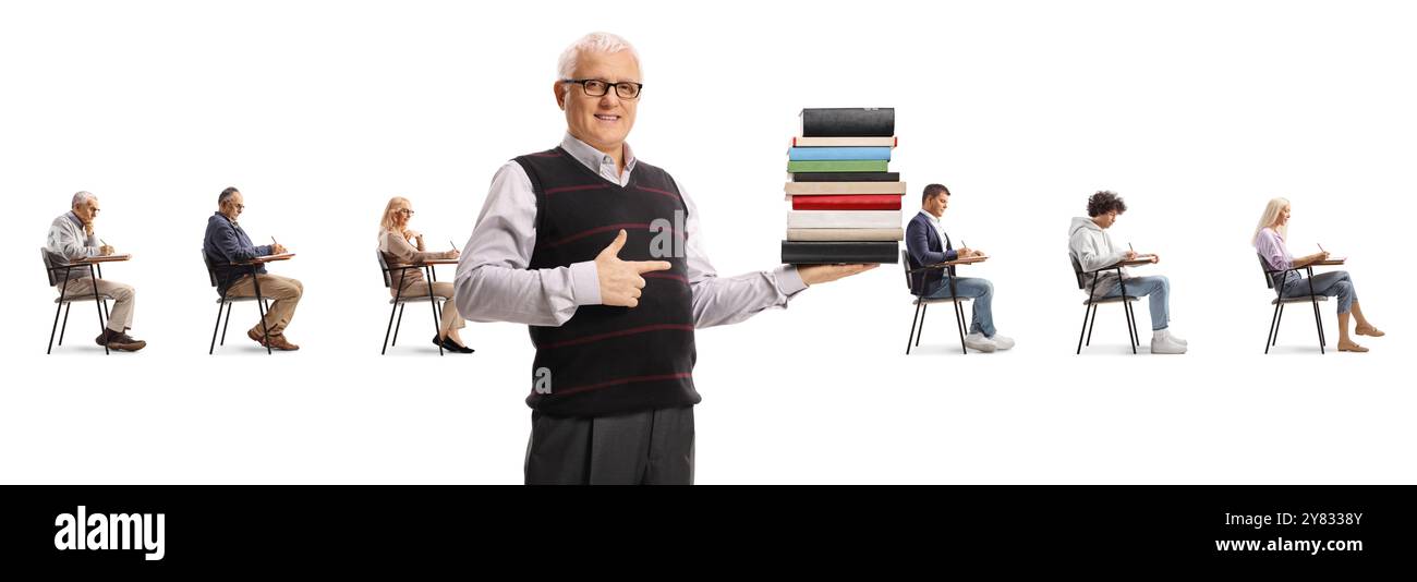 Man pointing at a pile of books and people sitting in school chairs in ...