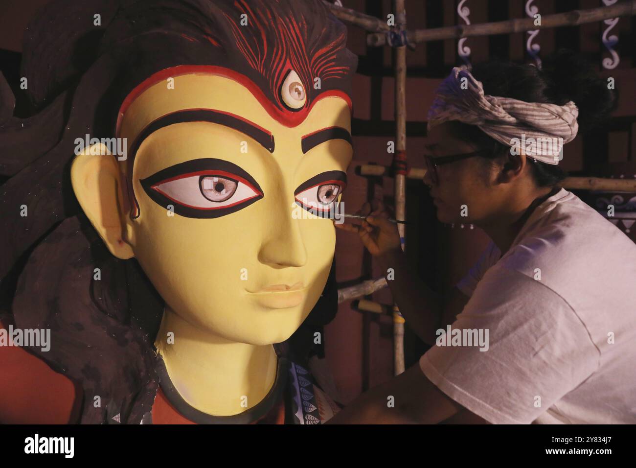 Kolkata, West Bengal, India. 2nd Oct, 2024. An artisan Upshona Chatterjee prepares idols of the ...