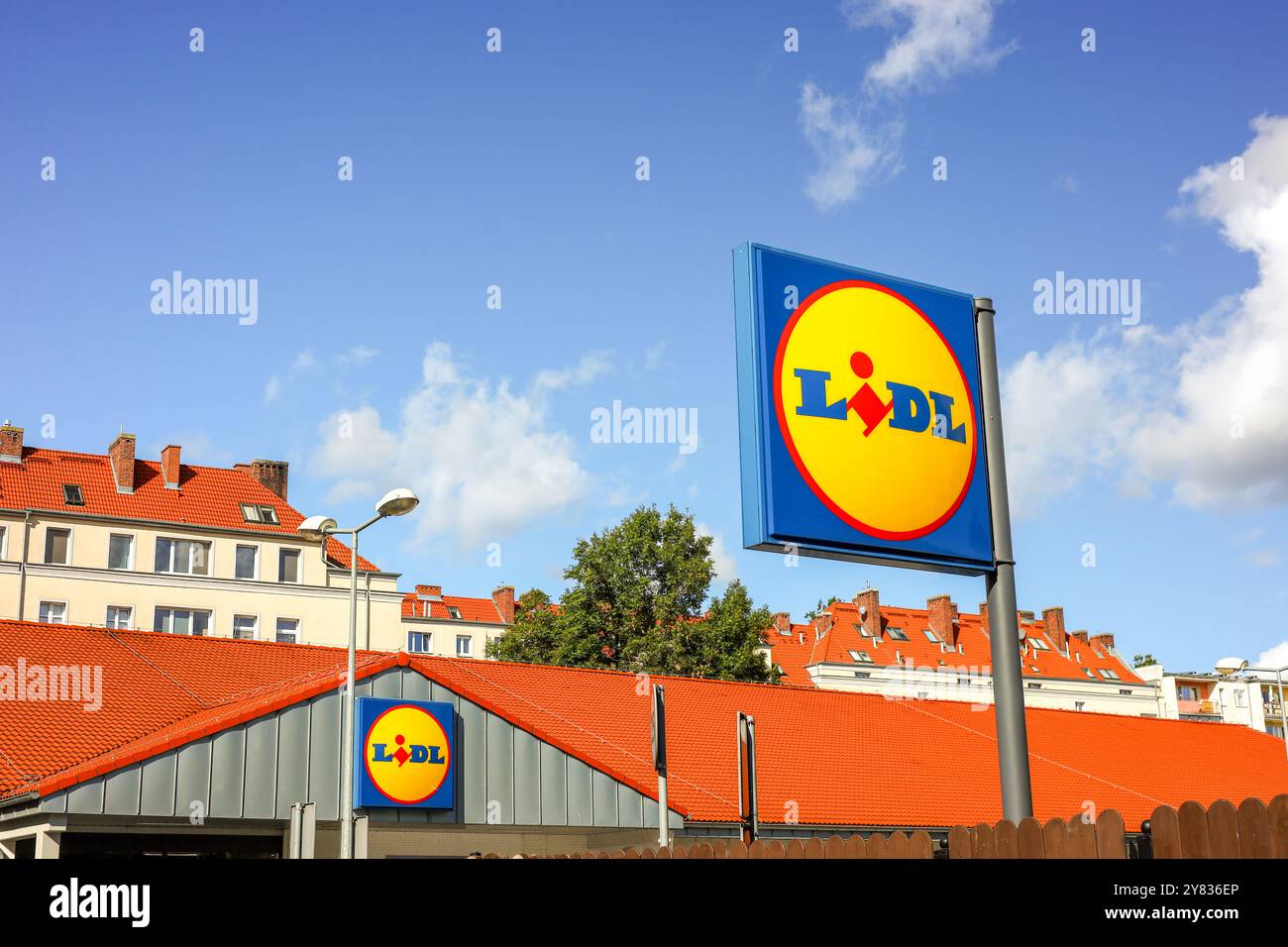 The logo of the LIDL chain of stores standing in front of the store ...