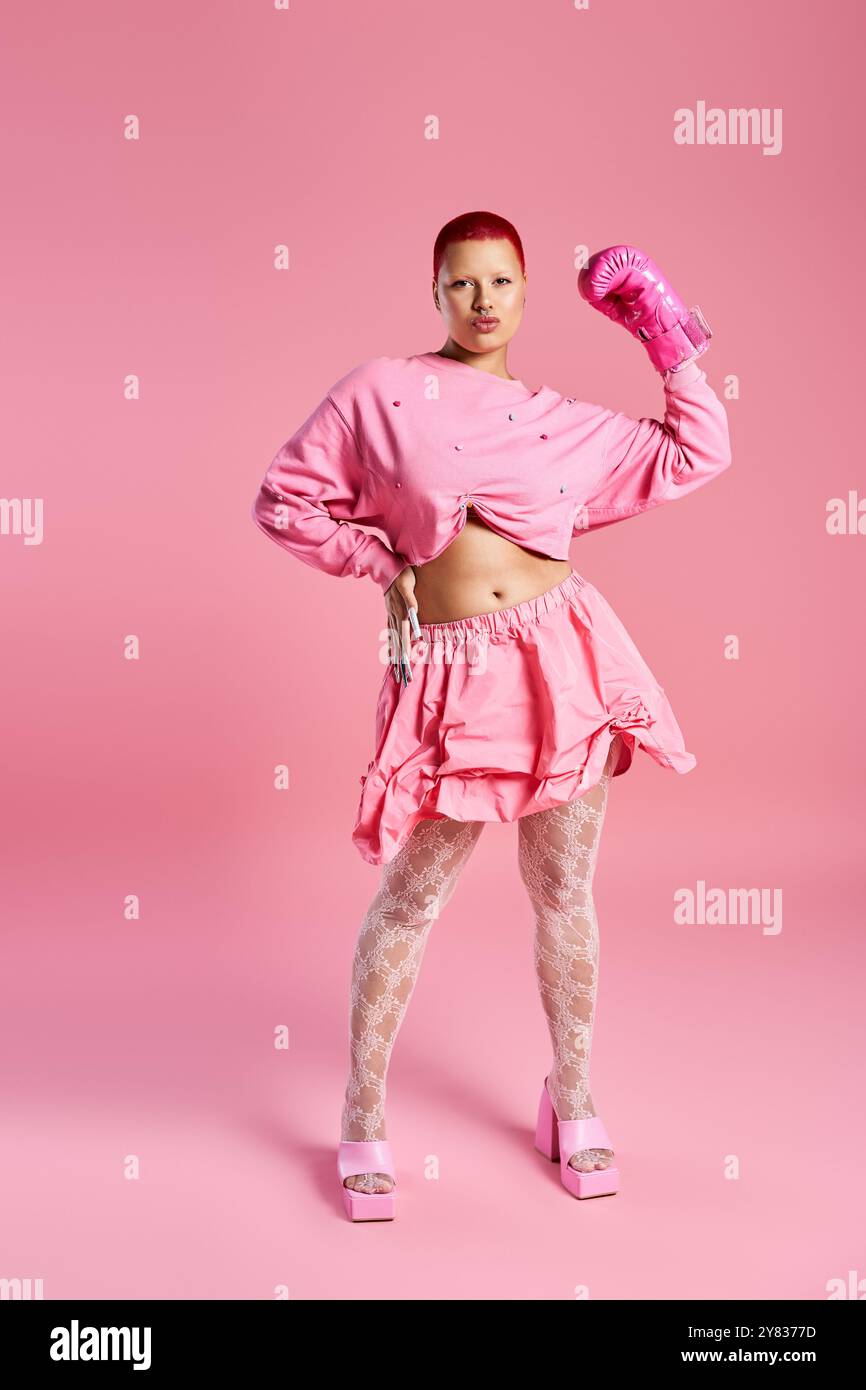 A vibrant studio displays a young woman with short pink hair flaunting ...