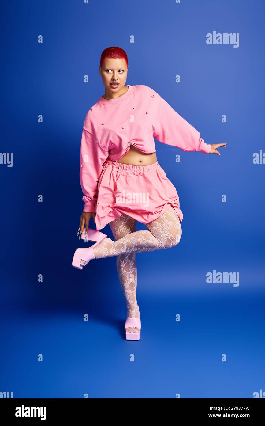 This bold individual with striking pink hair poses playfully ...