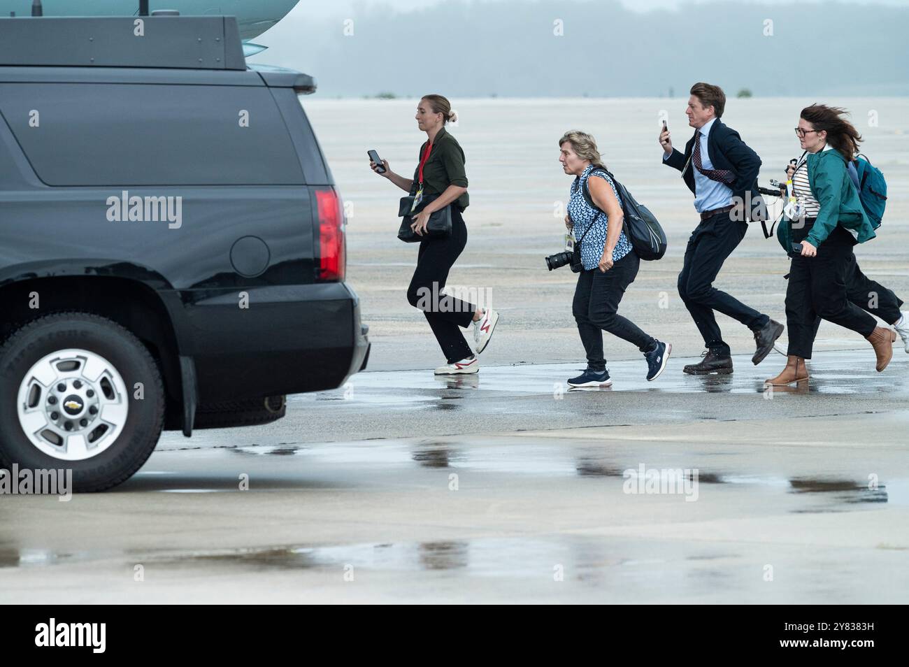 Members of the White House Press Corps run to speak with President Joe Biden before he boards ...