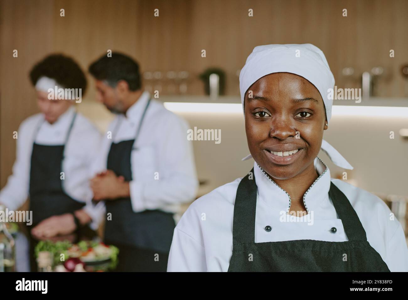 Medium close up portrait of adorable African American cook in white ...