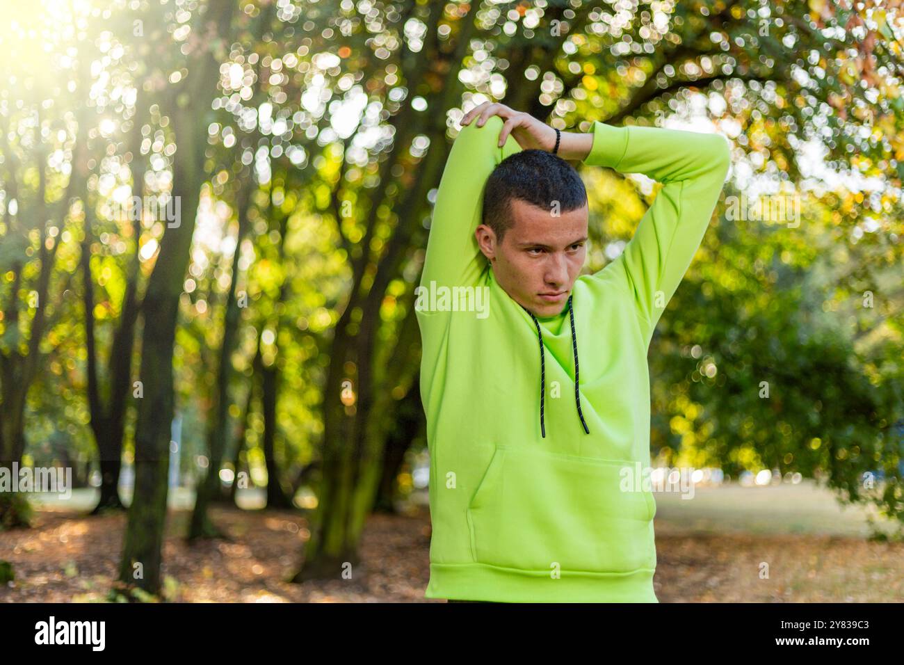 Sport man stretching at the park autumn, doing exercises.Handsome man ...