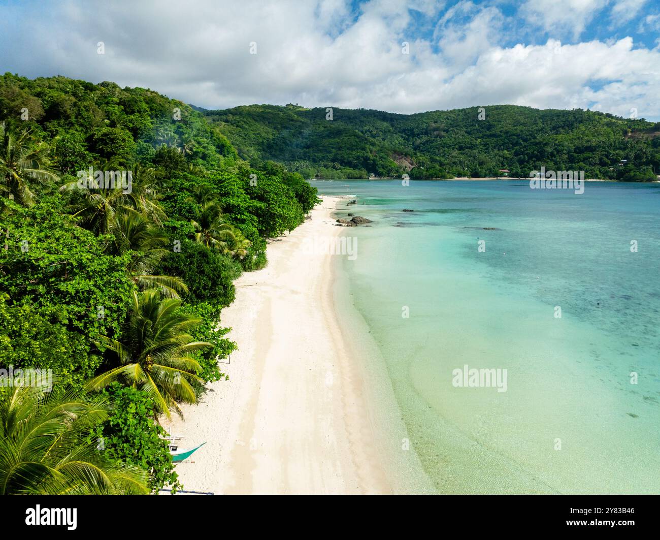 Drone view of coastline with sandy beach and clear water in Tiamban ...