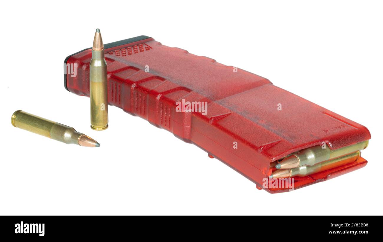 Assault rifle magazine that is red that is filled to capacity with ammo ...