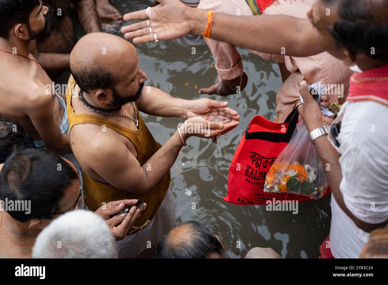 Hindu devotees perform the 'Tarpan' ritual during Mahalaya prayers ...