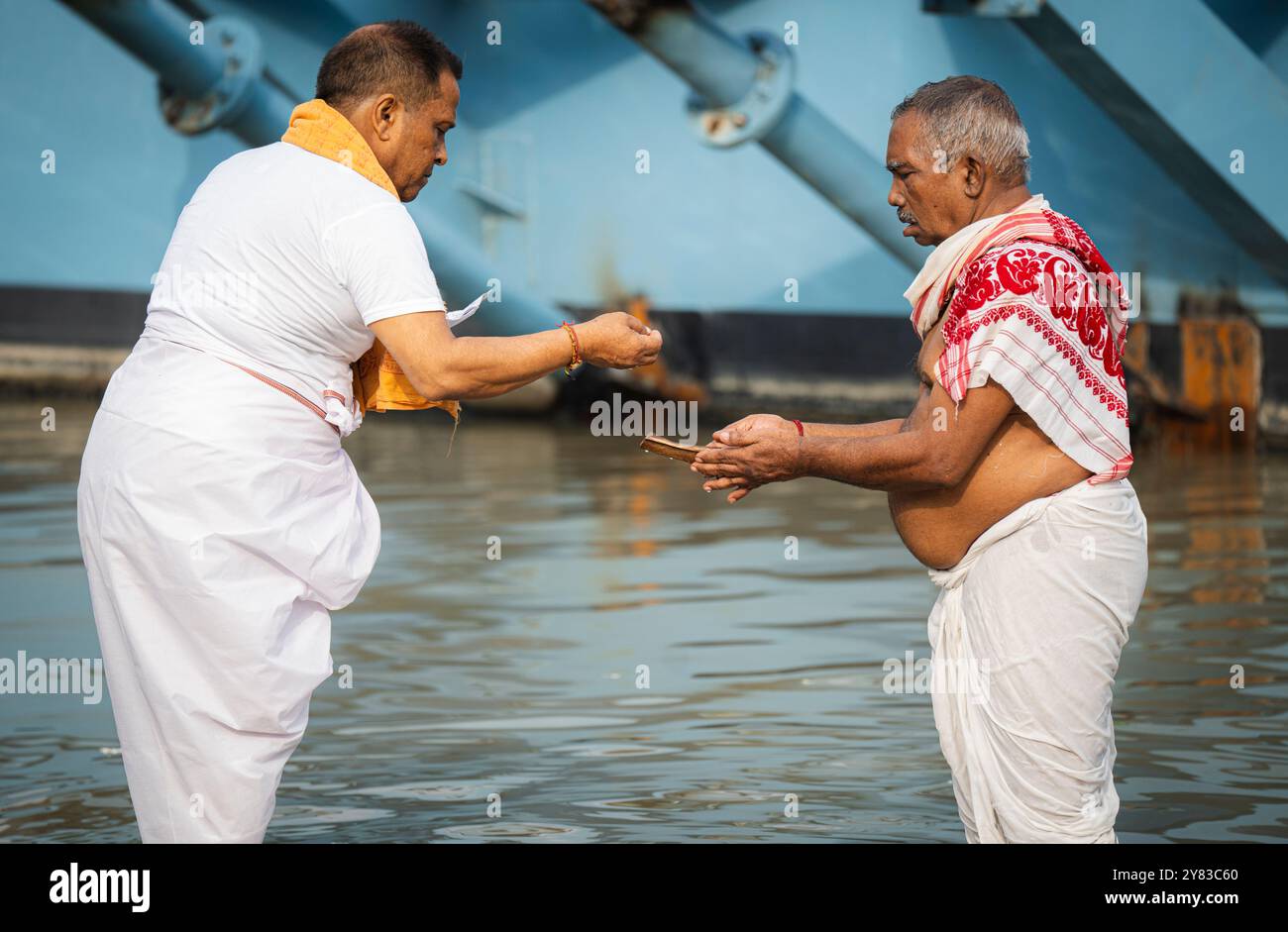 Hindu devotees perform the 'Tarpan' ritual during Mahalaya prayers ...