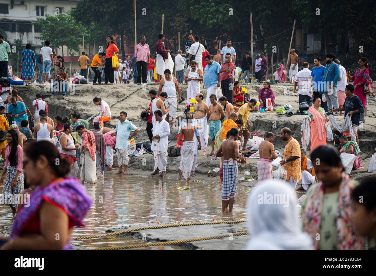 Hindu devotees perform the 'Tarpan' ritual during Mahalaya prayers ...