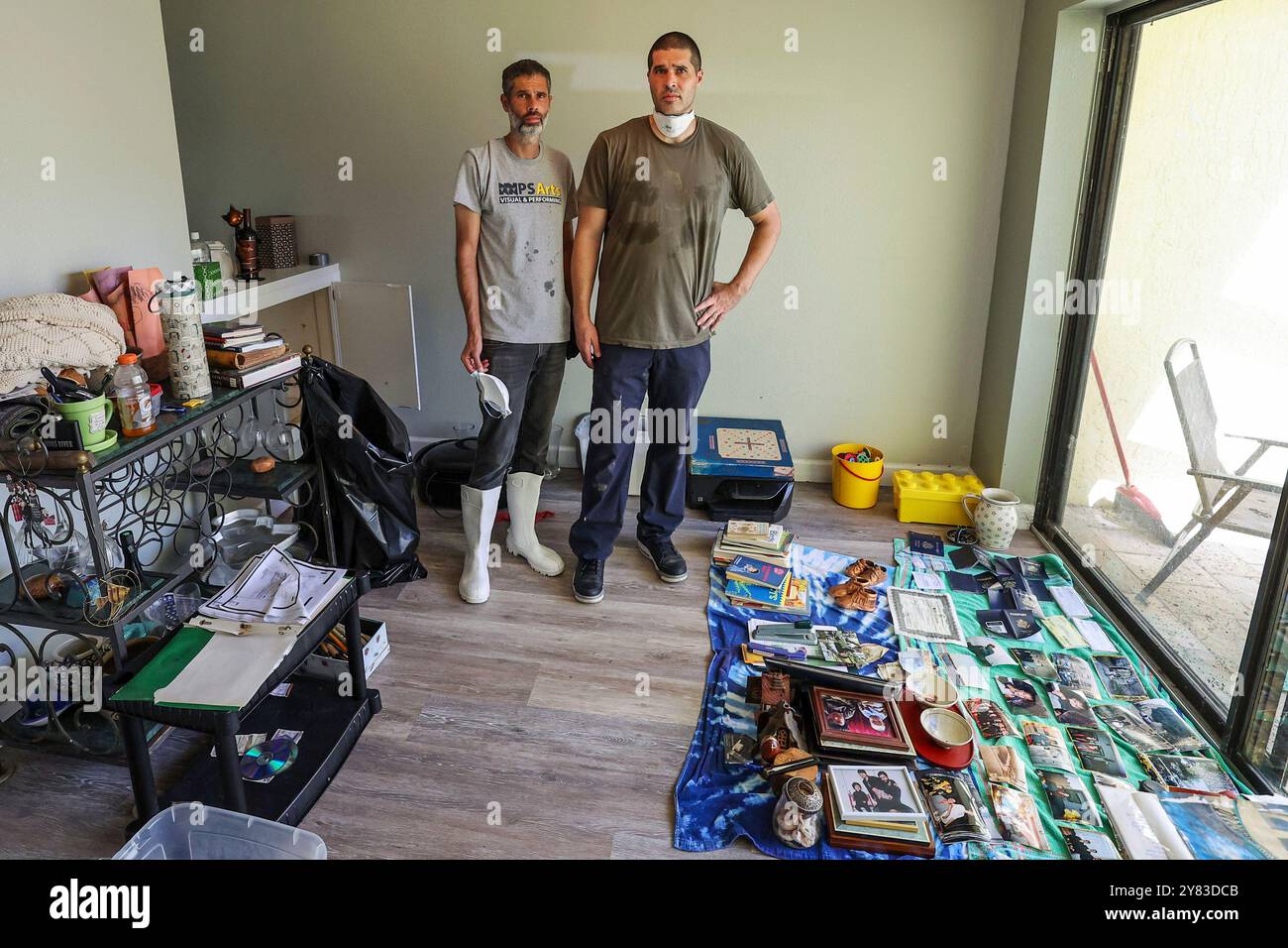Miles Runner, left, and his brother Chris pause while cleaning out the ...