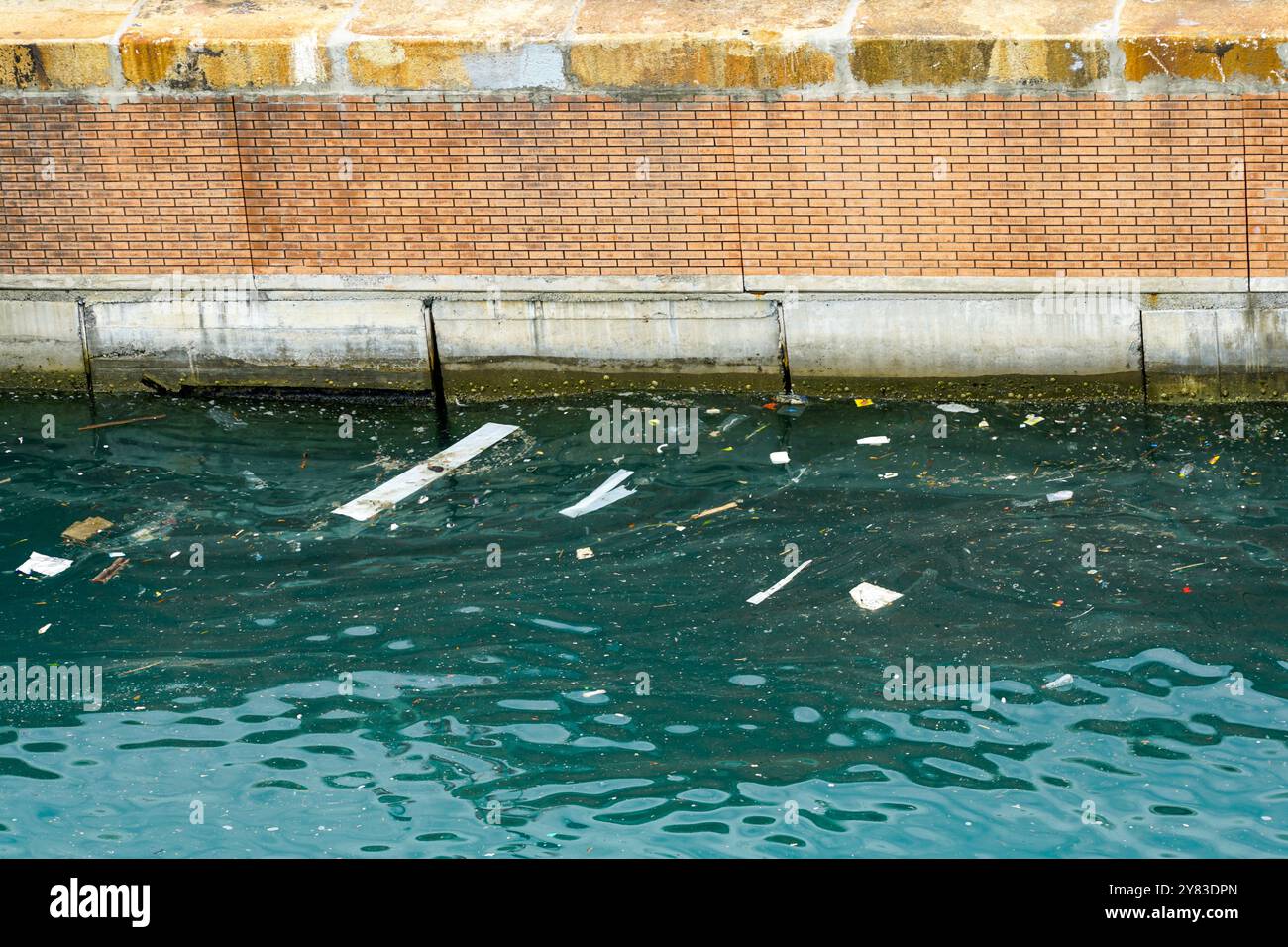 Various wastes in Mediterranean port embankment blue water ...