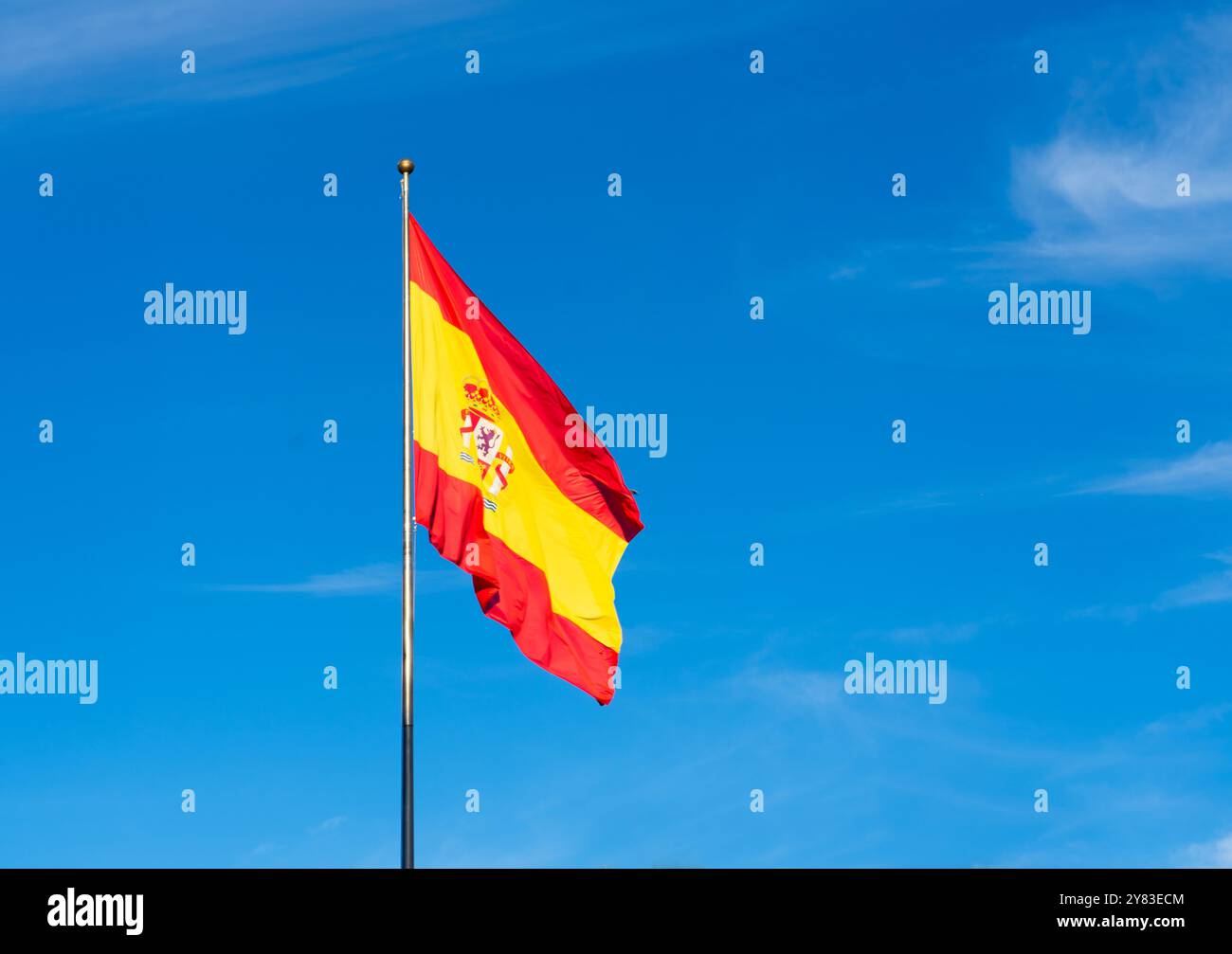 Spanish flag waving in a clear blue sky Stock Photo - Alamy