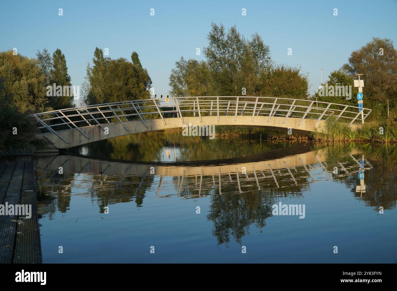 Bridge reflection in water Stock Photo - Alamy