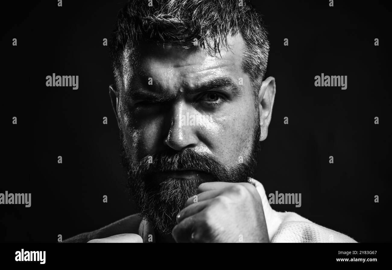 Portrait serious karate man in kimono in fighting position. Bearded man ...