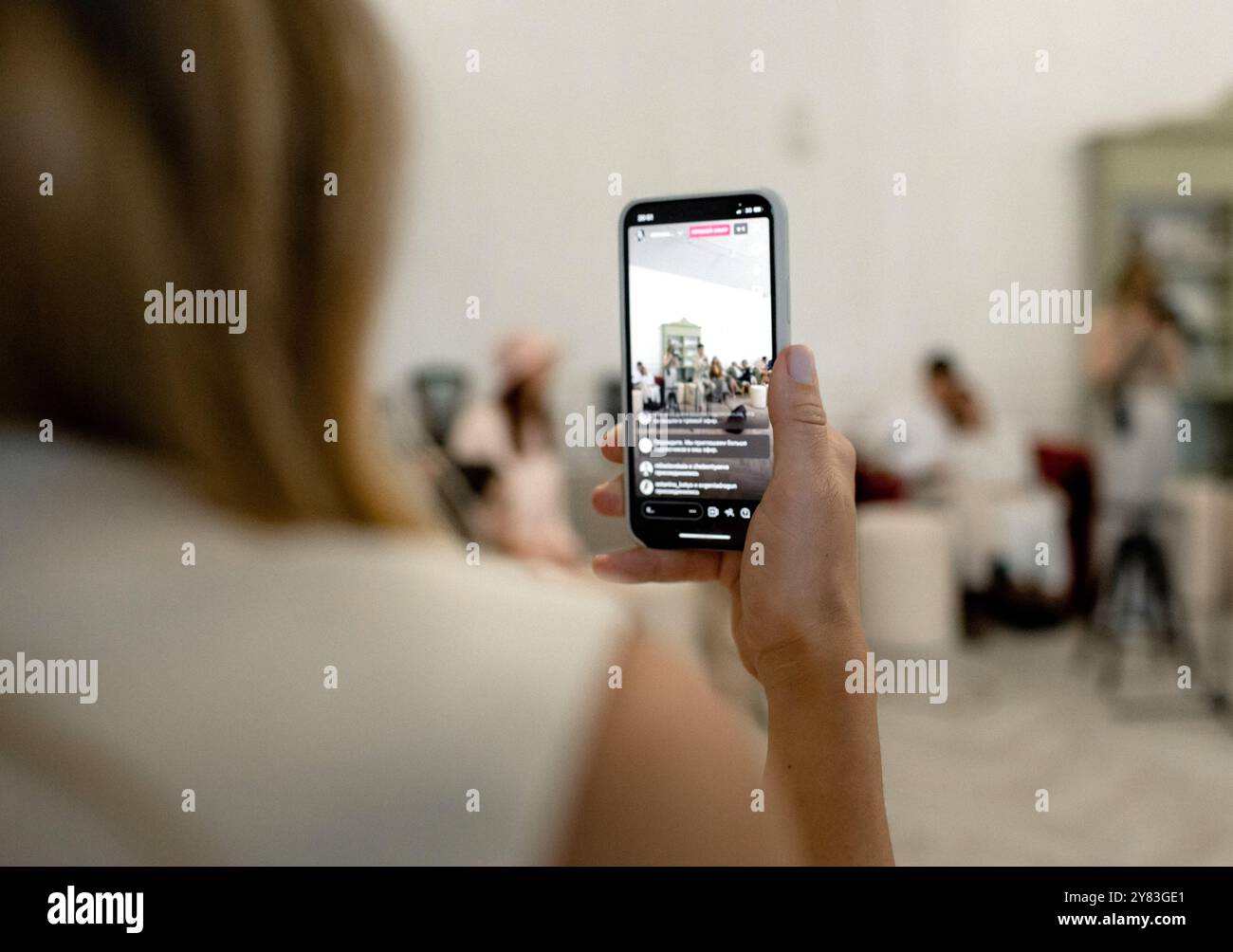 Two people, dressed elegantly, are joyfully cutting a lavish wedding ...
