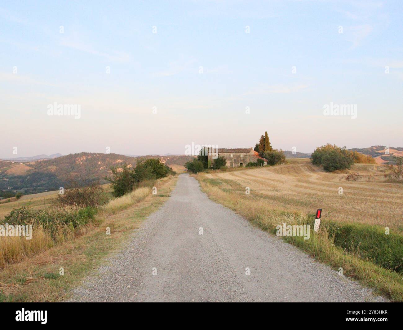 Country house overlooking a small alley in the autumn hills Stock Photo ...