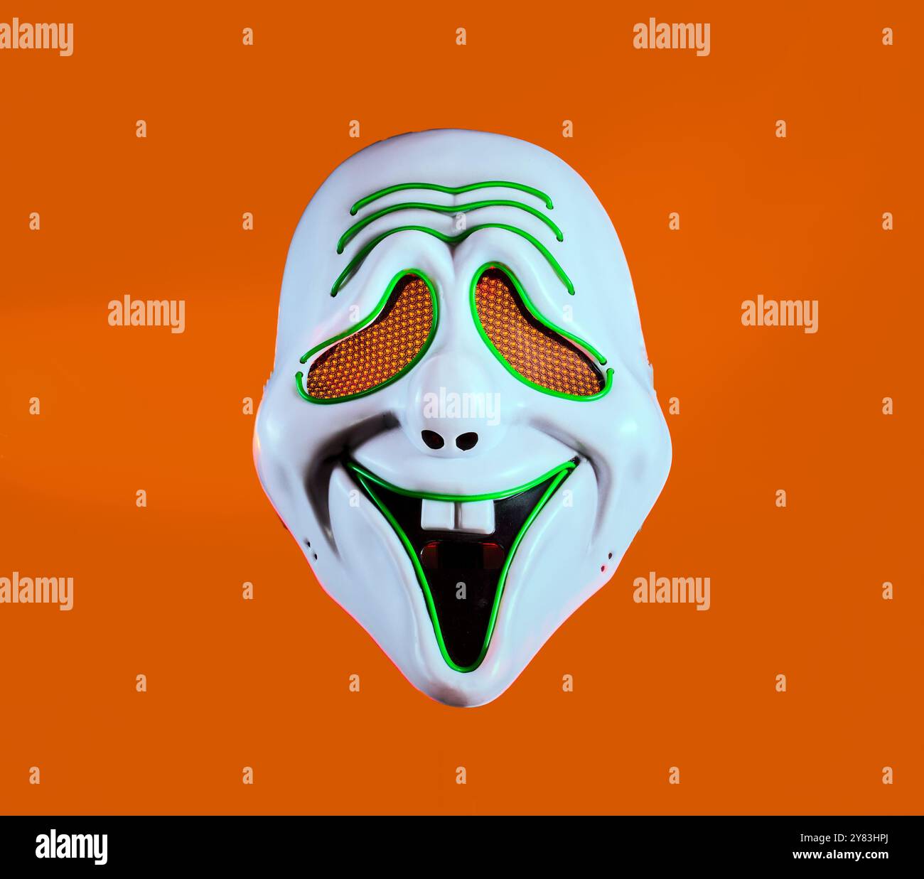 Scary halloween mask on a orange background Stock Photo - Alamy