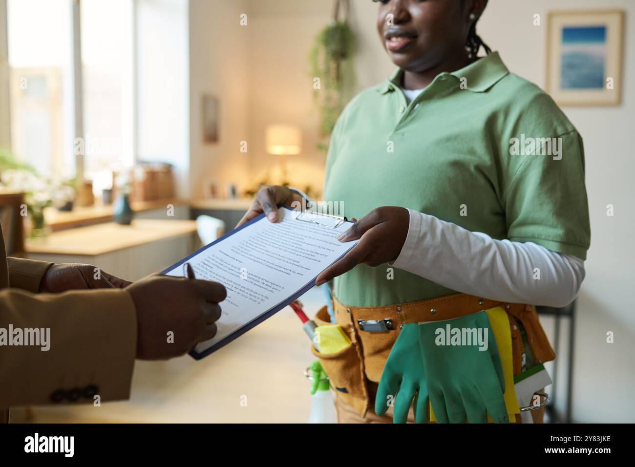 Housemaid Giving Contract to Client Stock Photo - Alamy