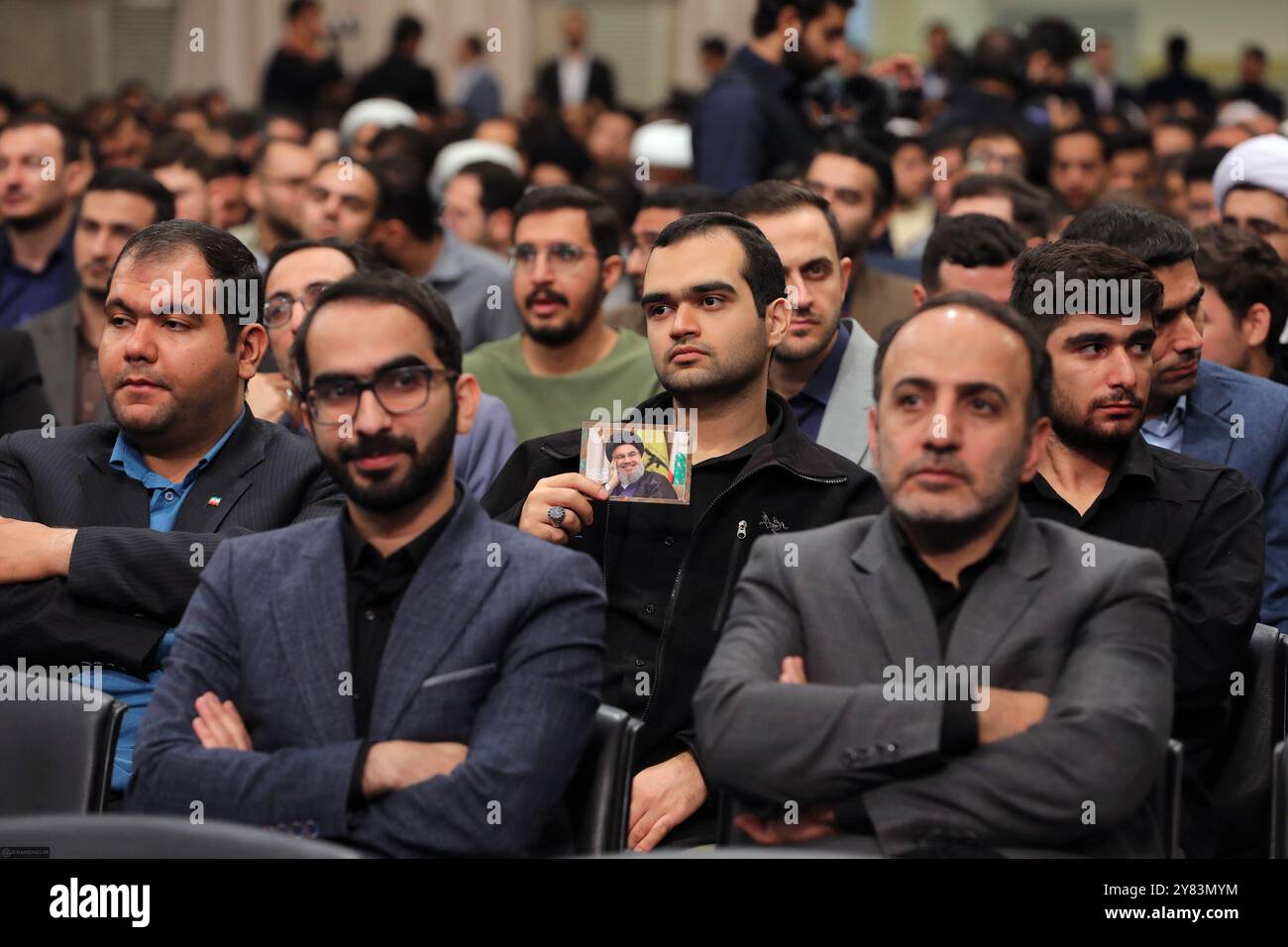 Tehran, Iran. 2nd Oct, 2024. An Iranian man holds a portrate of the ...