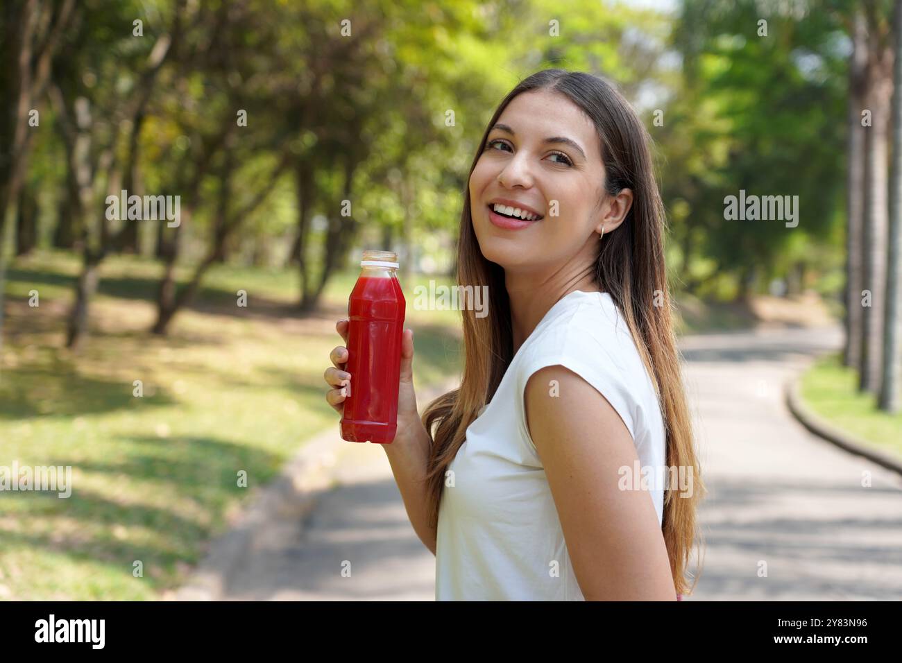 Brazilian young woman drinking red detox juice with beetroot orange ...