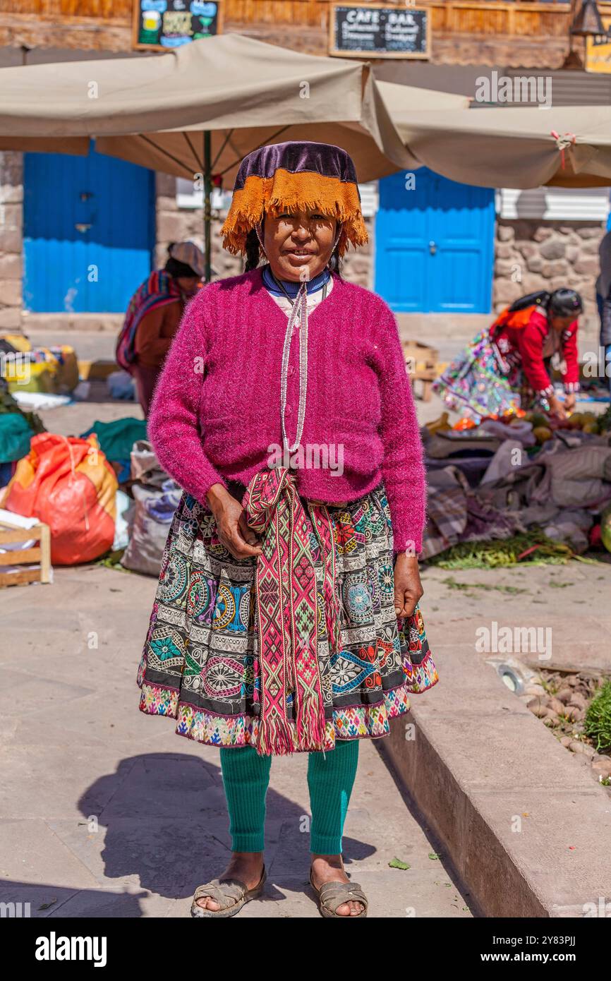 Quechua woman wearing traditional headgear and clothing in Pisac market ...