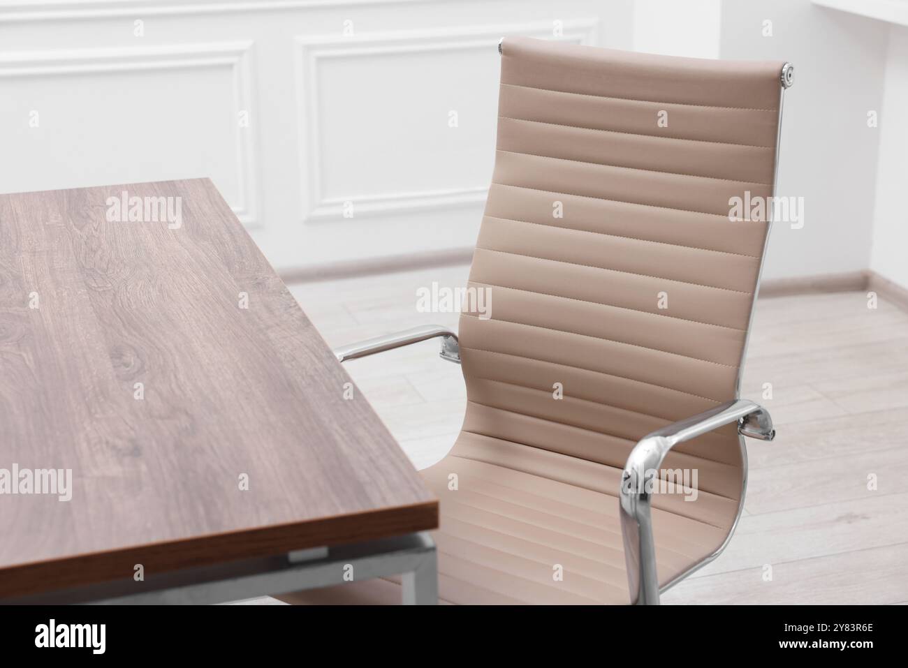 Beige leather chair and desk in office Stock Photo - Alamy