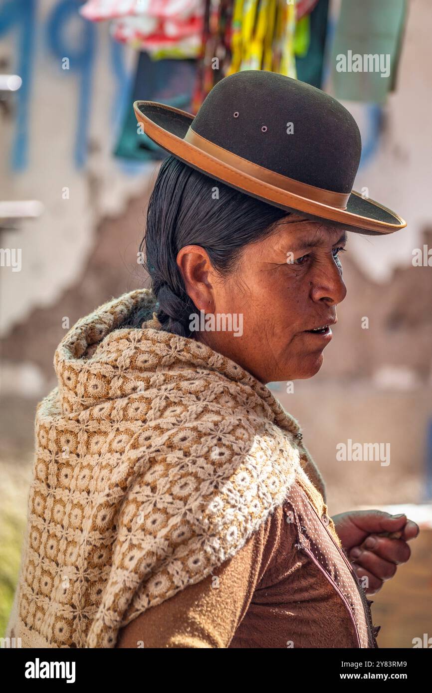 Local Quechua woman wearing traditional dress including the manta ...