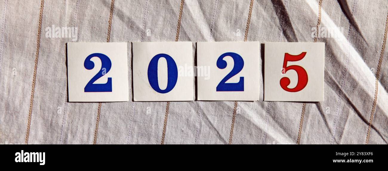 Numbers of 2025 year. Paper square numbers on the surface of wrinkled ...