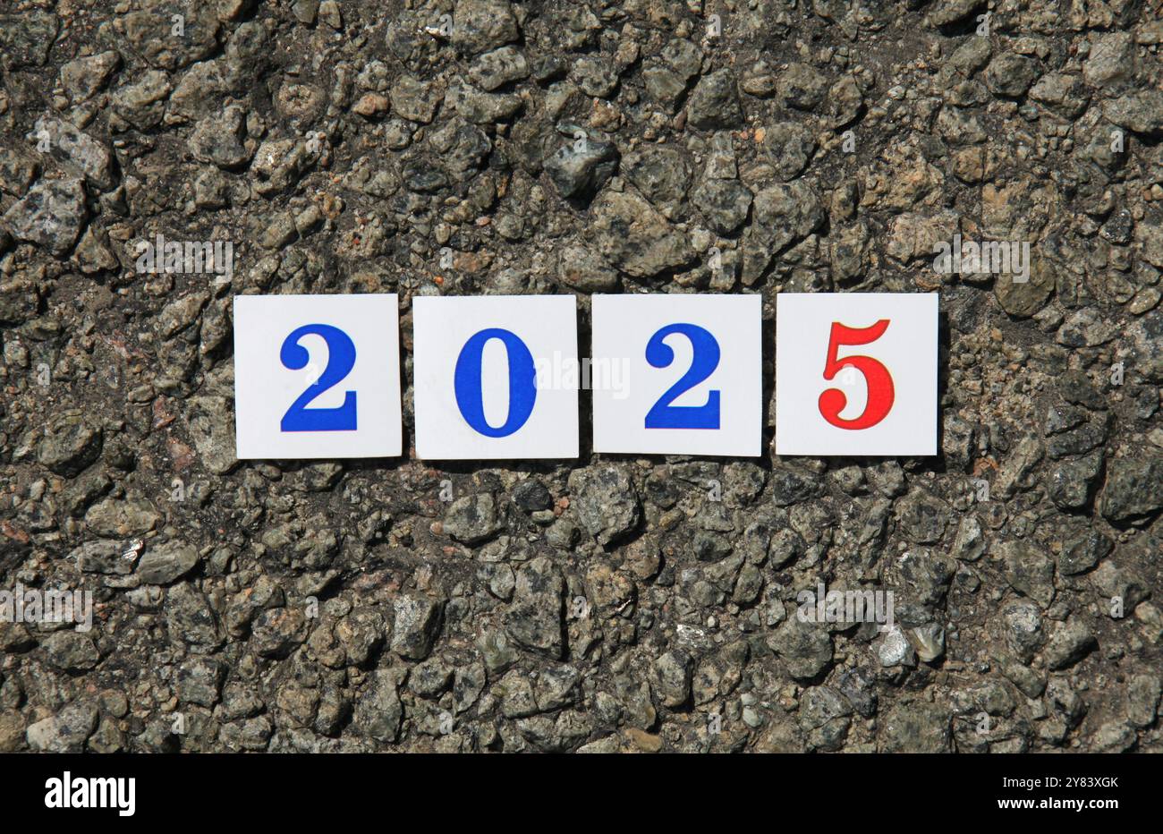 Numbers of 2025 year. Paper square numbers on the stone road background ...