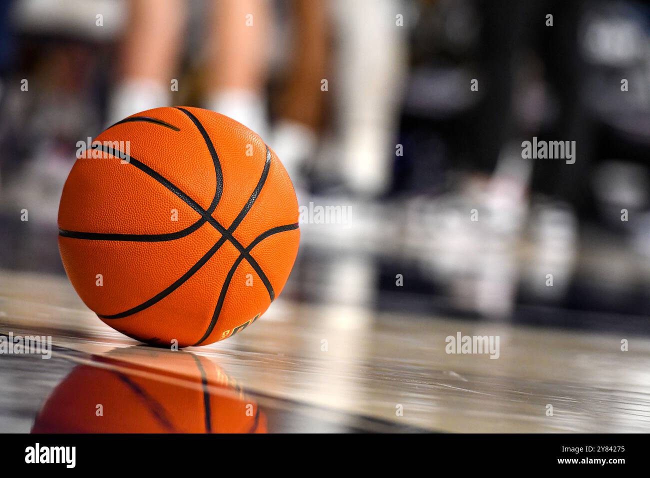A Close-Up of a Basketball Resting on a Shiny, Polished Hardwood Court ...