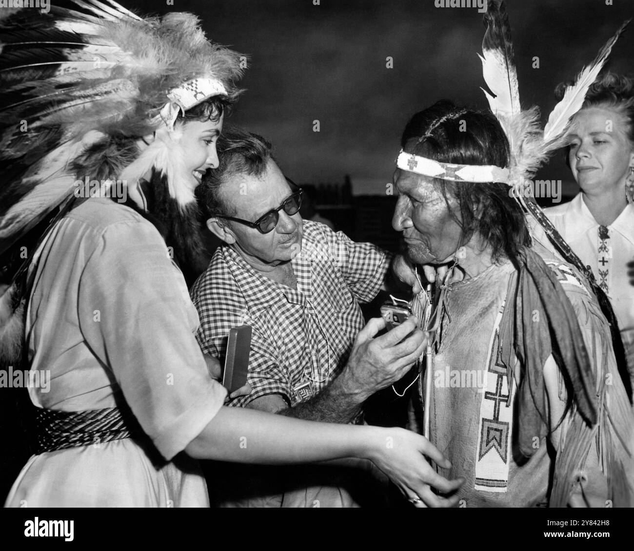 Suzan Ball (left), John Sitting Bull being given a hearing aid (left ...