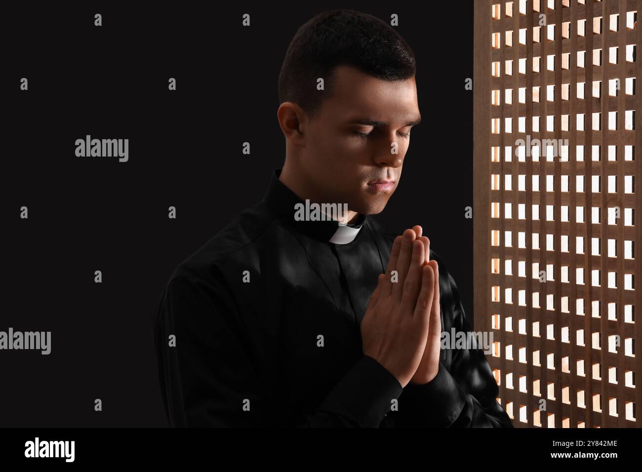Young catholic priest in black hi-res stock photography and images - Alamy