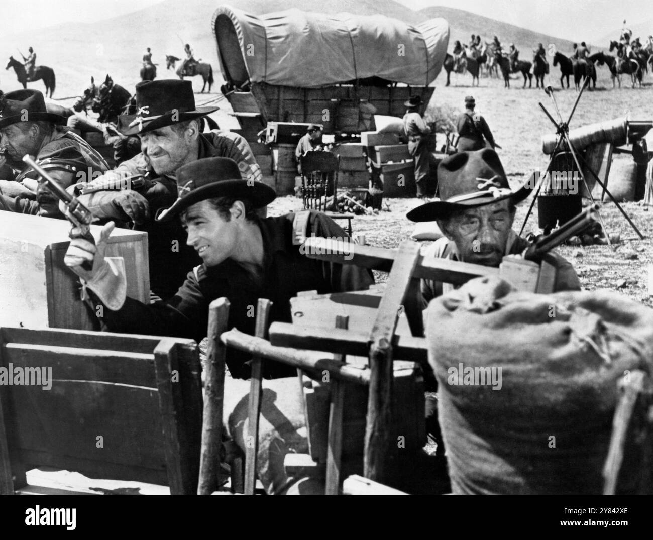 James Whitmore (foreground, left), Guy Madison (foreground, right), on-set of the western film ...