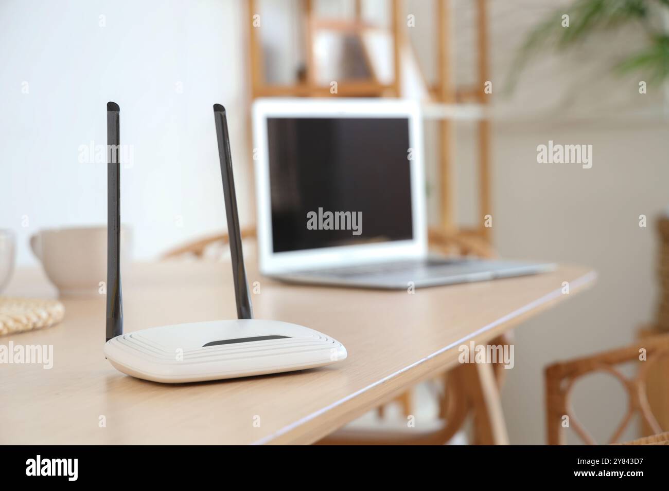 Modern wi-fi router on dining table in light room, closeup Stock Photo ...