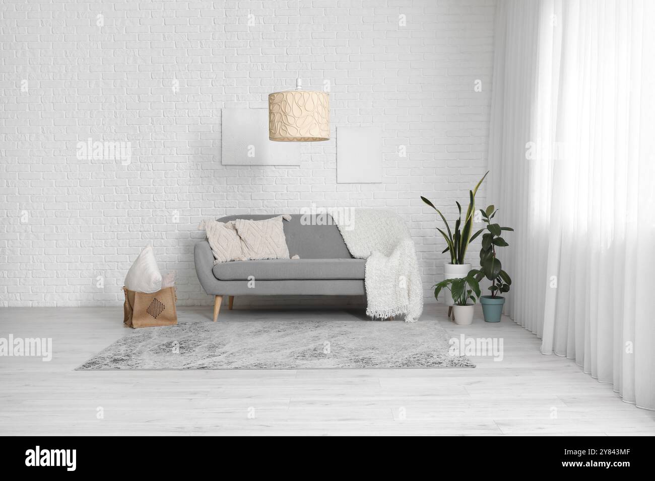 Interior of stylish living room with cozy sofa near window Stock Photo ...