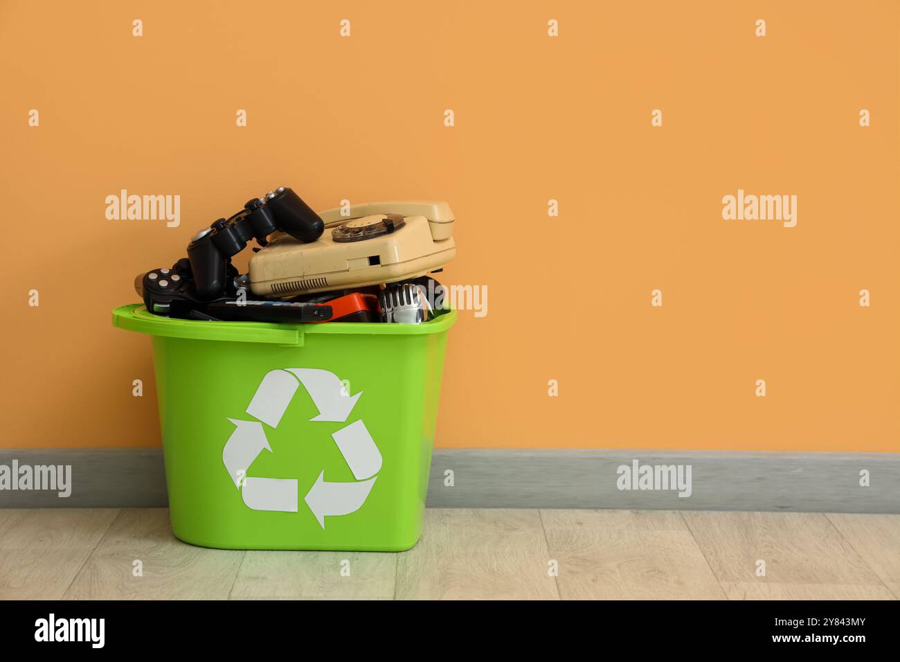 Recycling bin with electronic near beige wall. Recycle concept Stock ...