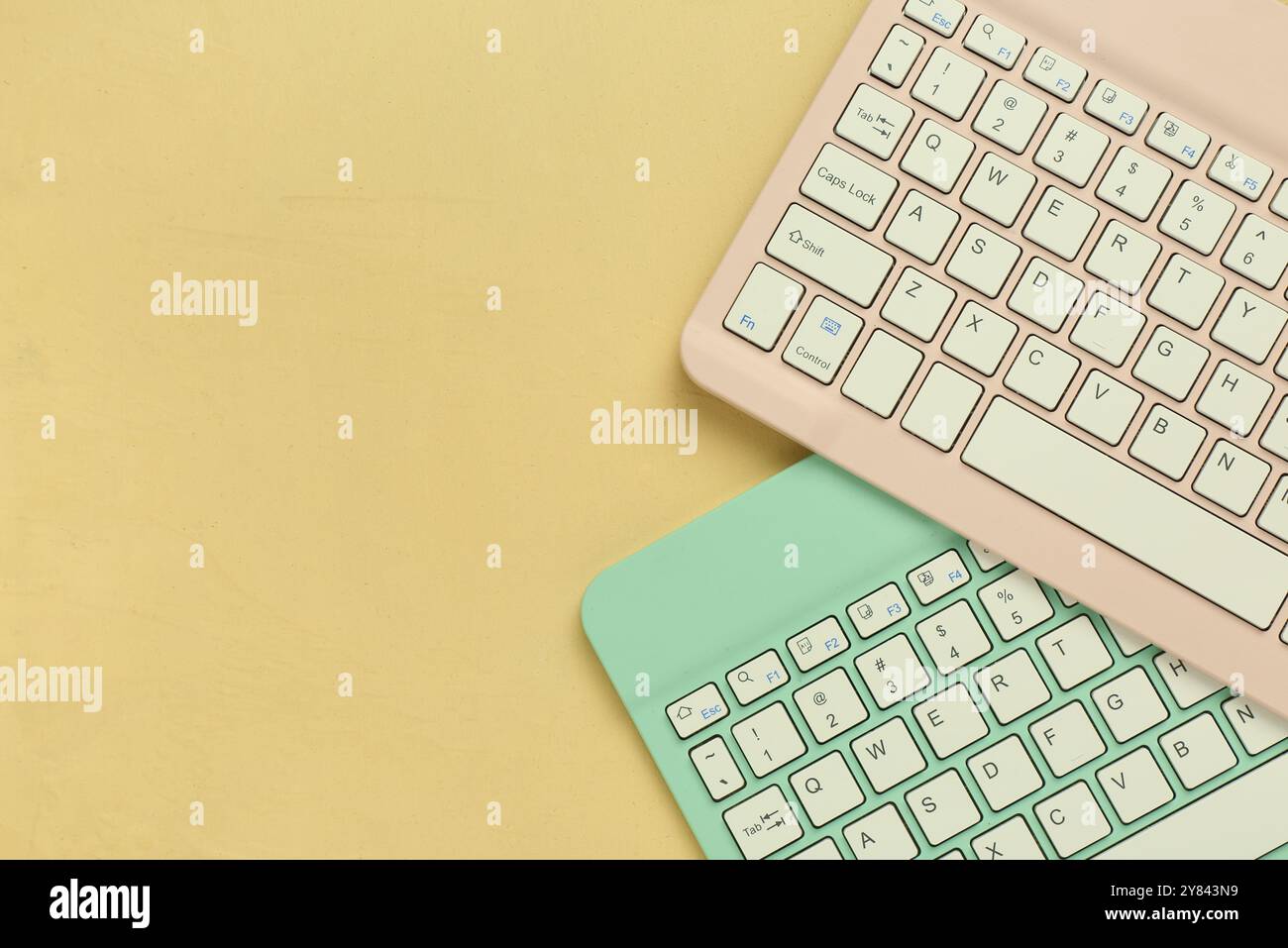 Modern tablets external keyboard on yellow background Stock Photo - Alamy