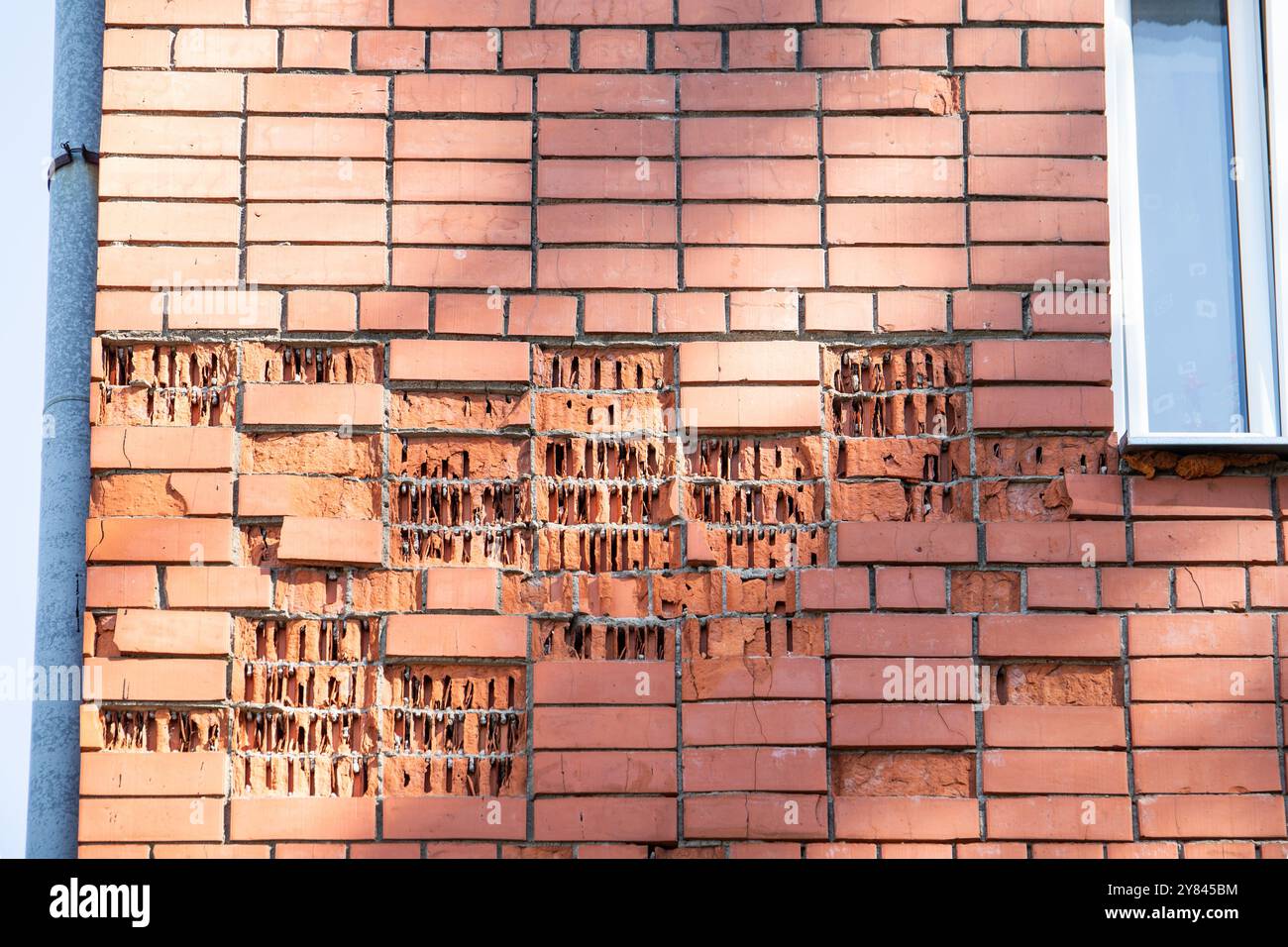Red brick facade. Damaged roof and water damage Stock Photo - Alamy