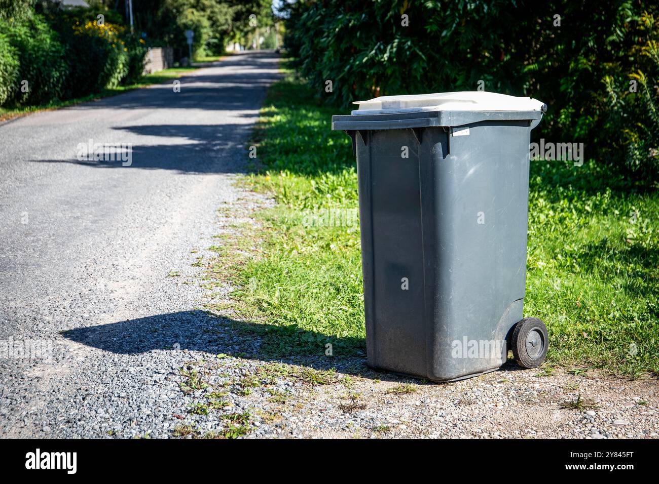 Gray garbage container on the side of the street Stock Photo - Alamy