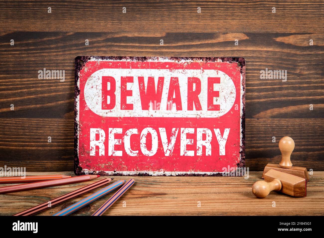 Recovery. Beware sign with text on a wooden texture office table Stock ...