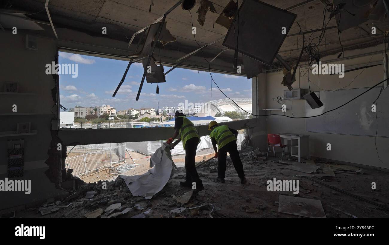 GEDERA, ISRAEL - OCTOBER 2: Workers remove rubble from a damaged ...