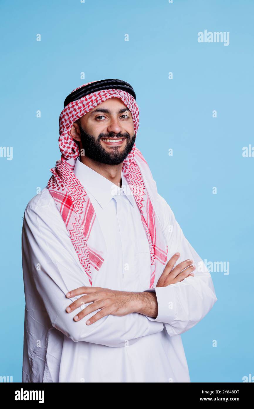 Happy arab man wearing traditional muslim headdress and robe standing ...