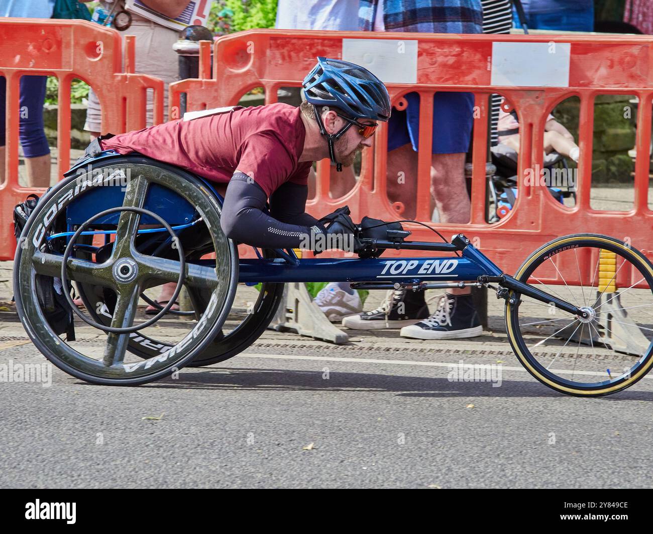 A man in a racing wheelchair competing in a half marathon Stock Photo ...