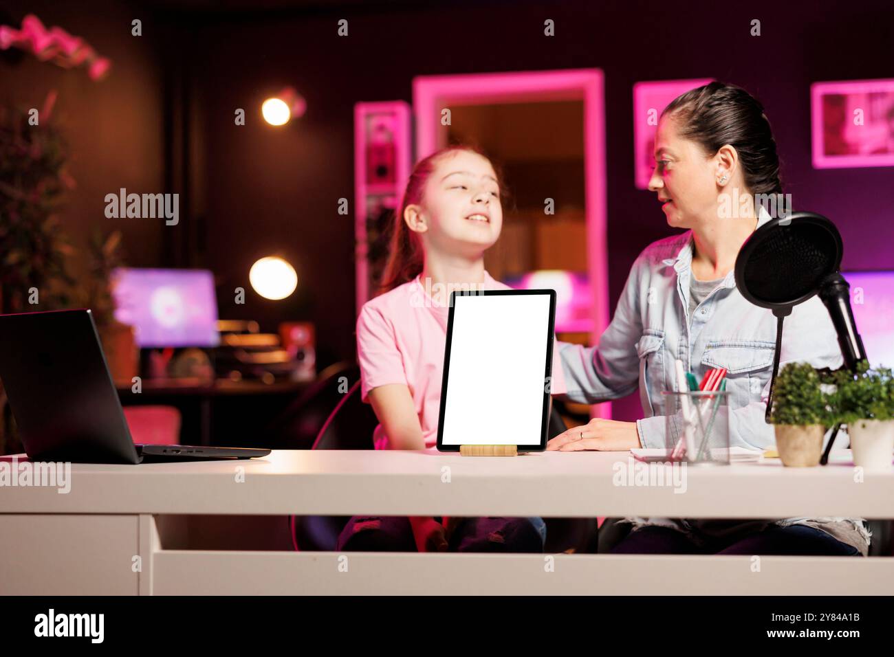 Child filming content with her mother about best mockup tablet on the ...