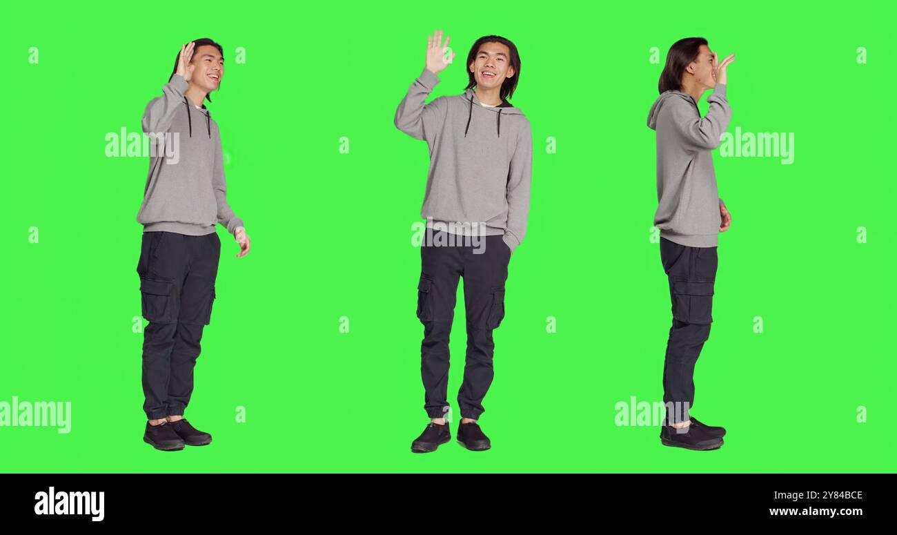 Asian man waving hello at people, greeting someone with a smile and ...