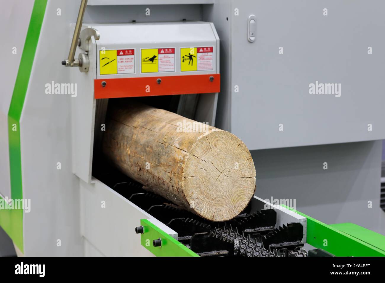 Log feeding into multi blade wood rip saw machine. Selective focus Stock Photo - Alamy